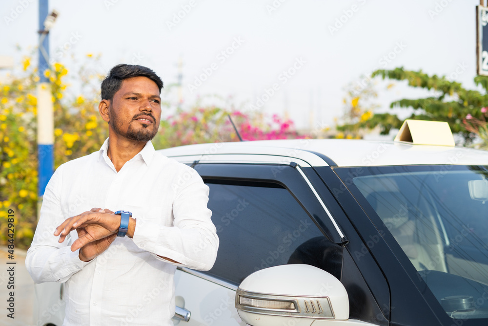 Worried indian cab driver waiting for customer in front of car ...