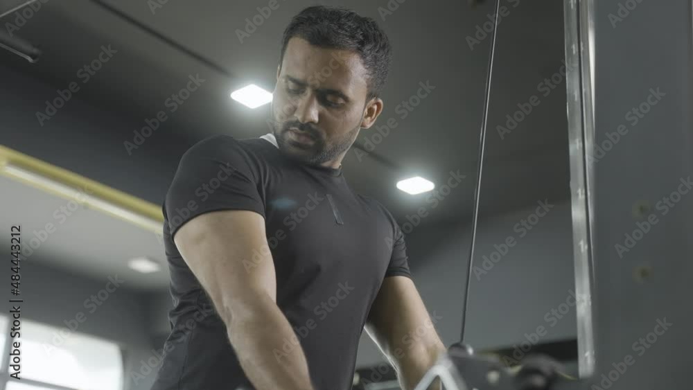 Young indian bodybuilder doing biceps workout at gym - concept of body ...