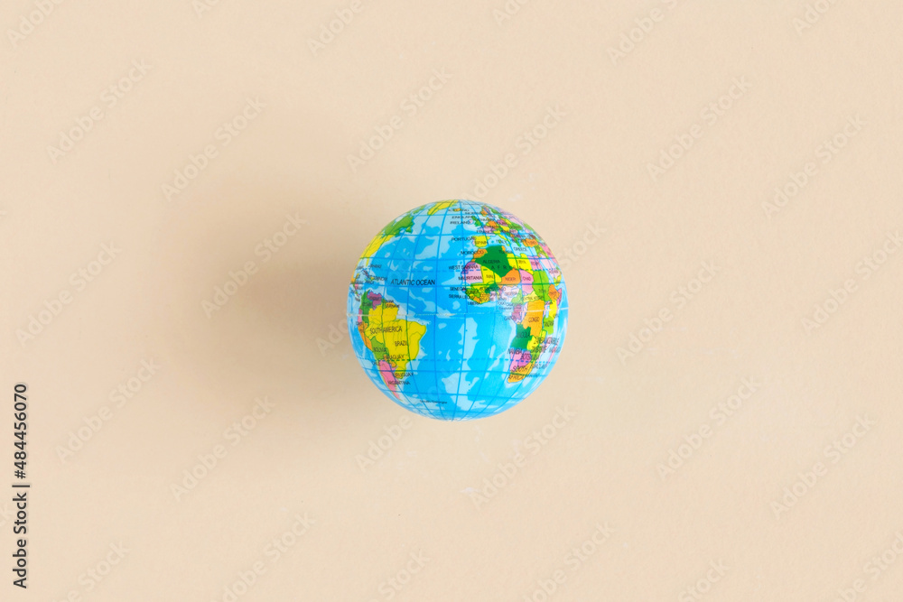Earth globe on isolated beige pastel background. Abstract wallpaper ...
