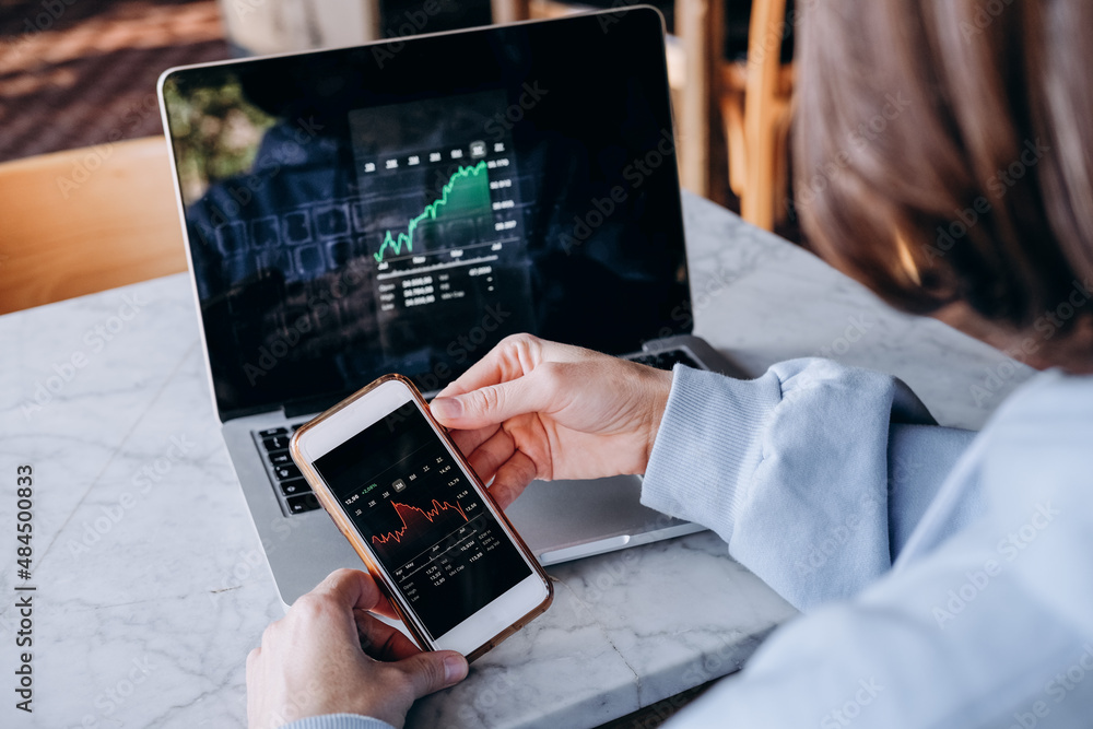 Stock market investor hands holding a phone investment app index growth ...