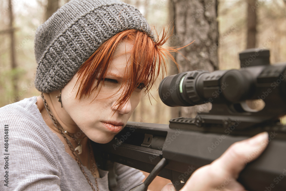 Beautiful and intense redhead sniper woman with short hair and stocking ...