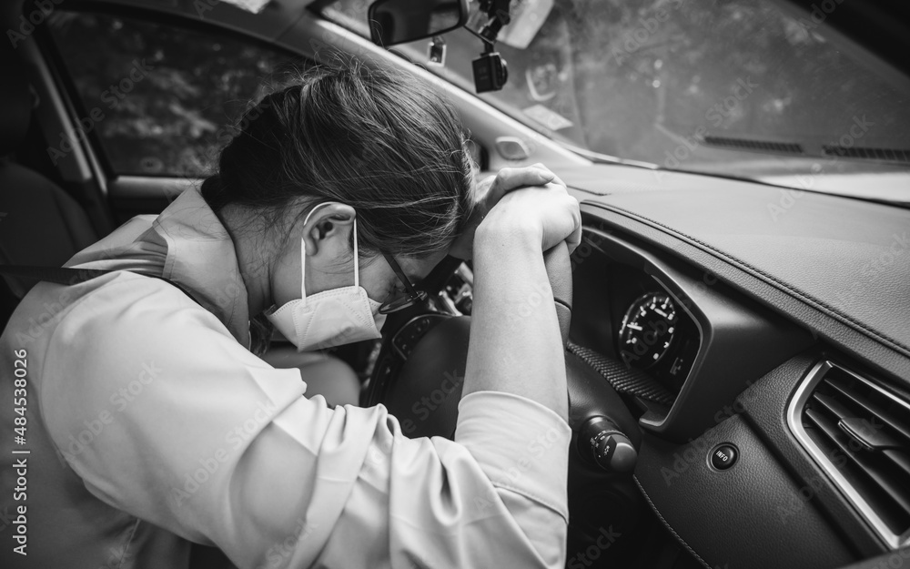 Asian woman wearing mask, napping in her car caused of tired from ...