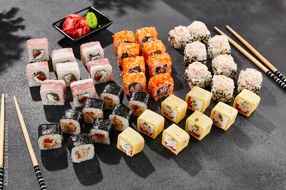 Maki sushi set on dark background. Big maki set with variety rolls ...