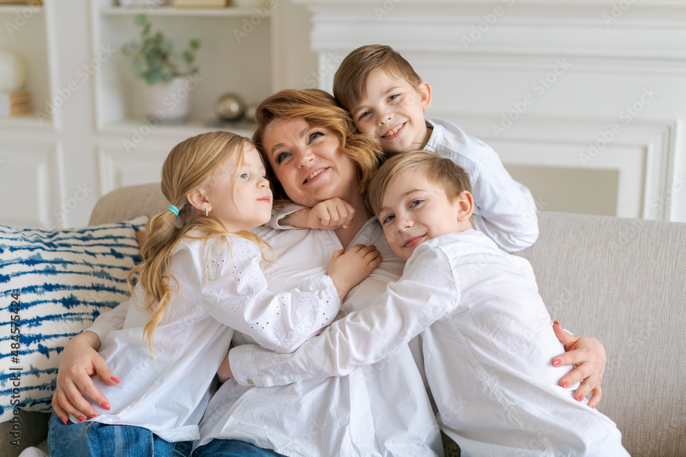 Foto de Cute kids hugging, excited mom showing love and affection ...