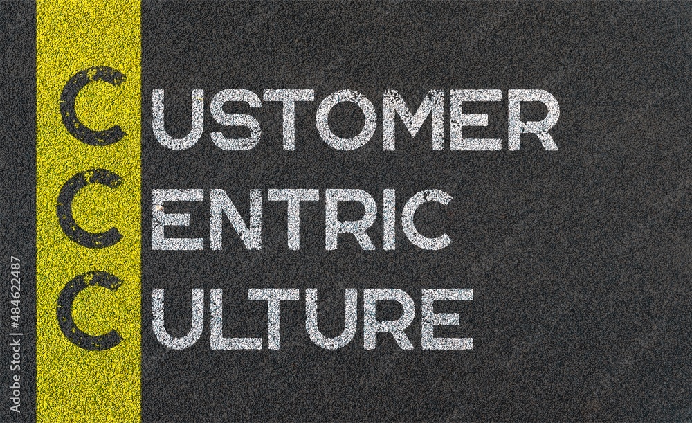 Customer centric culture (CCC) written over road marking yellow paint ...