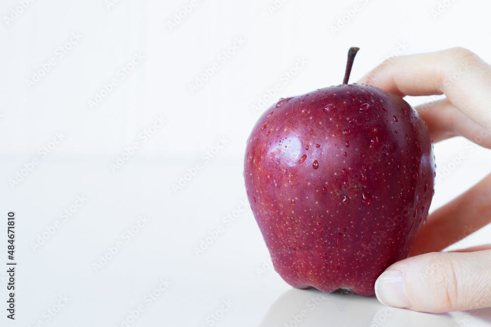 Woman's hand holding organic juicy Red Delicious apple isolated on ...