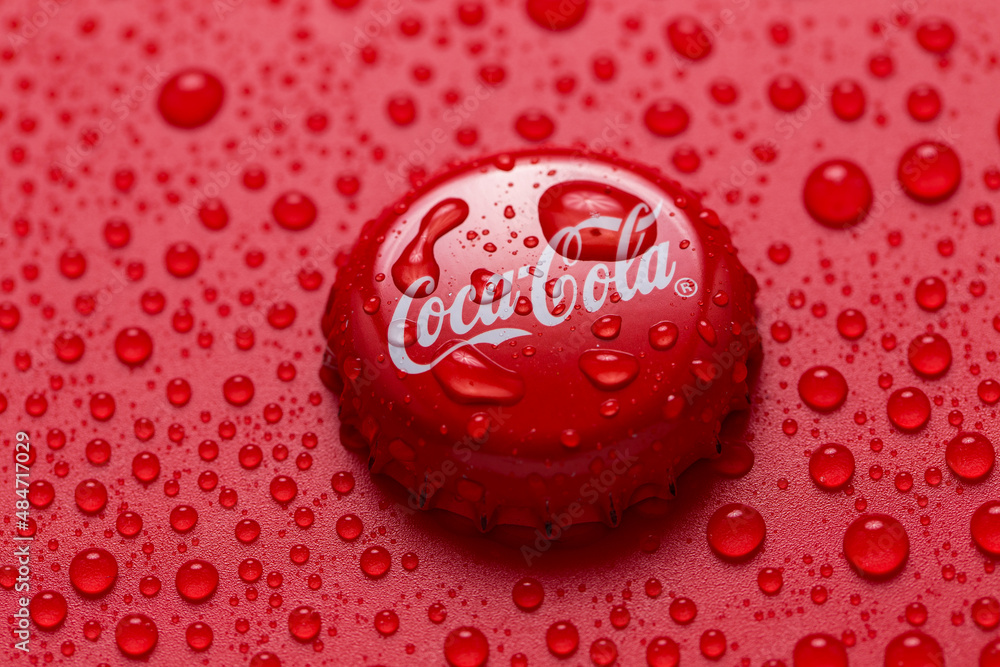 classic cap close-up of Coca-cola. Cap of cola on a red background with ...
