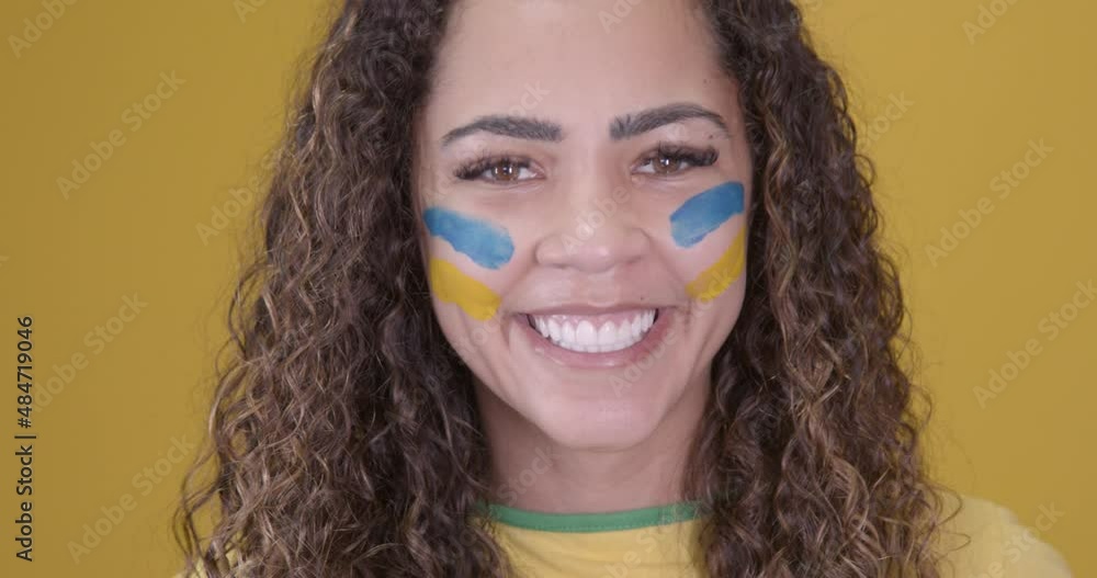 Afro woman, latin american, brazilian fan, with close-up on her face ...