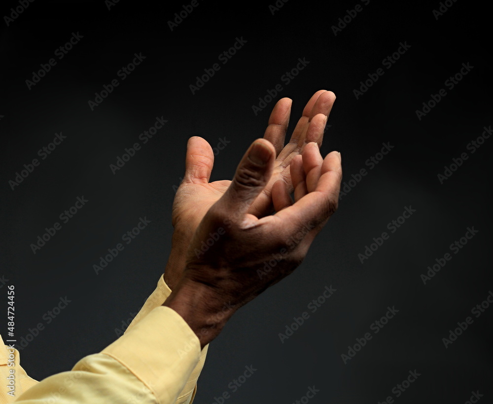 man praying to god with hands together on dark background stock photo ...