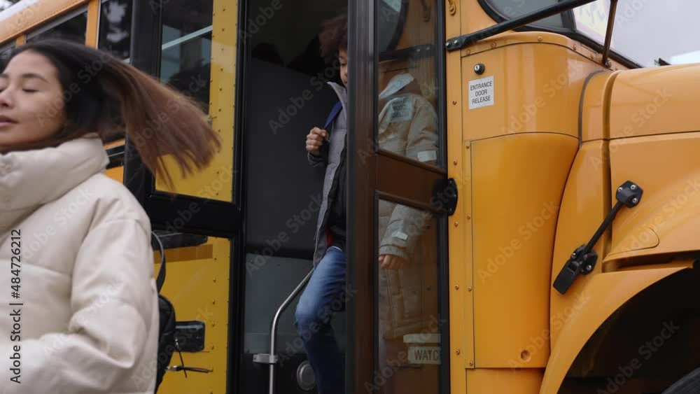 Close-up of multiracial teenage high school students walking down steps ...