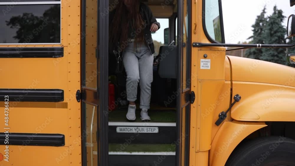 Close-up of yellow school bus opening doors and cheerful multinational ...
