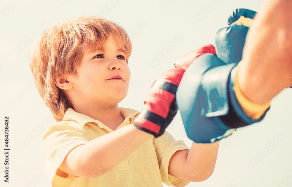 Father is training his son boxing. Little boy doing boxings exercise ...