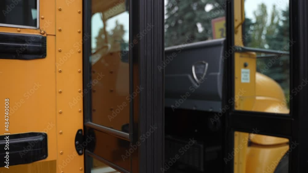 Close-up of yellow school bus opening doors and multiracial secondary ...