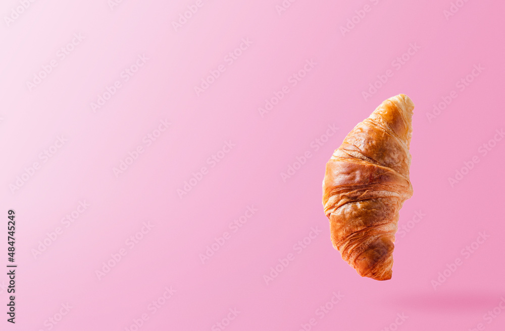Freshly baked croissant levitating or flying. Croissant fly in the air ...