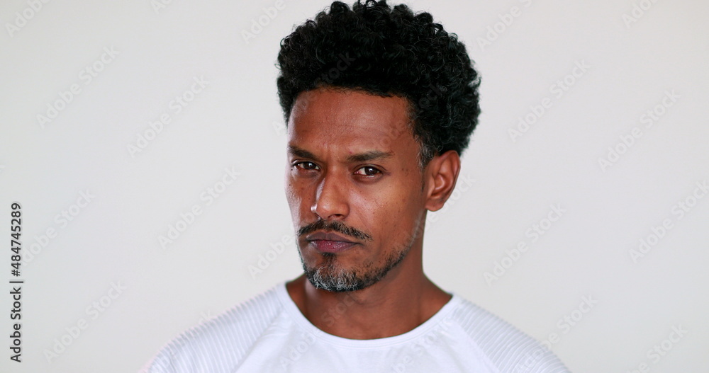 Suspicious black African man reaction to camera. Portrait guy reacting ...