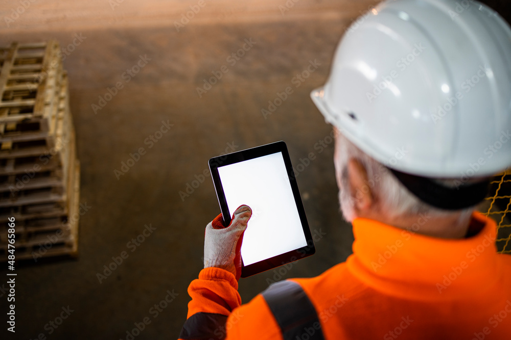 Top view of factory worker wearing safety uniform and hard hat, using ...