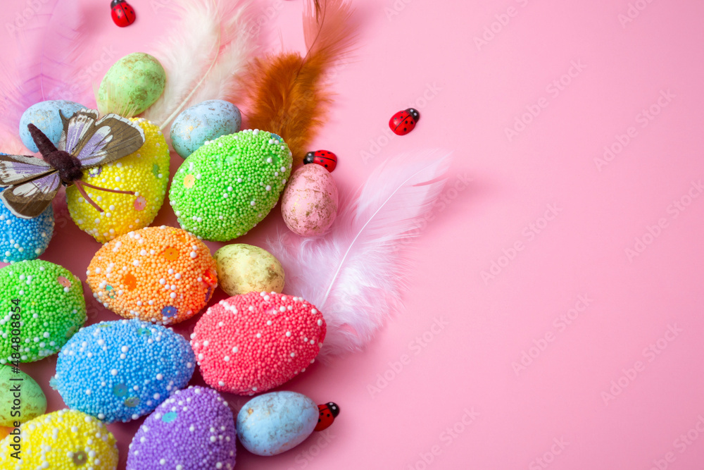 Easter background with Easter eggs and spring flowers on a pinki ...