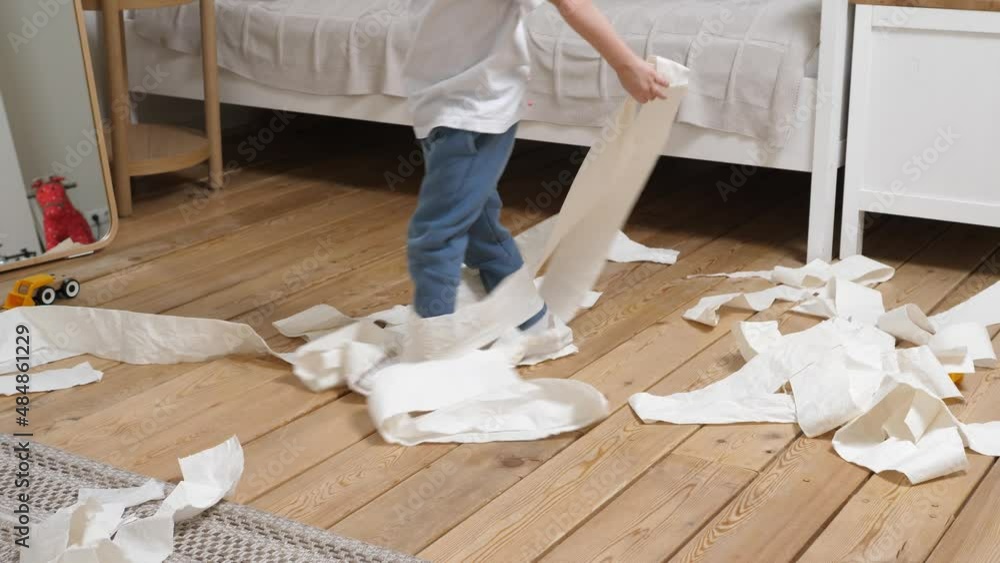 Small child has made a mess, scattered toilet paper around the ...