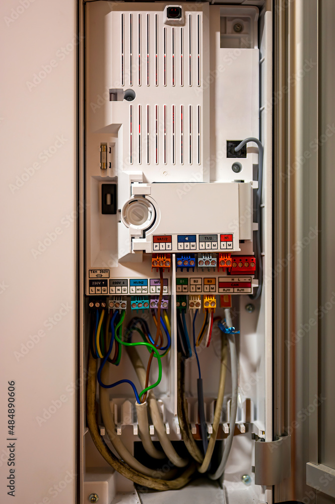 Open control box of a modern heating system with visible wiring. The ...