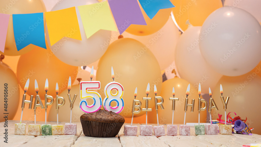 Happy birthday greetings for 58 years from gold letters of candles ...