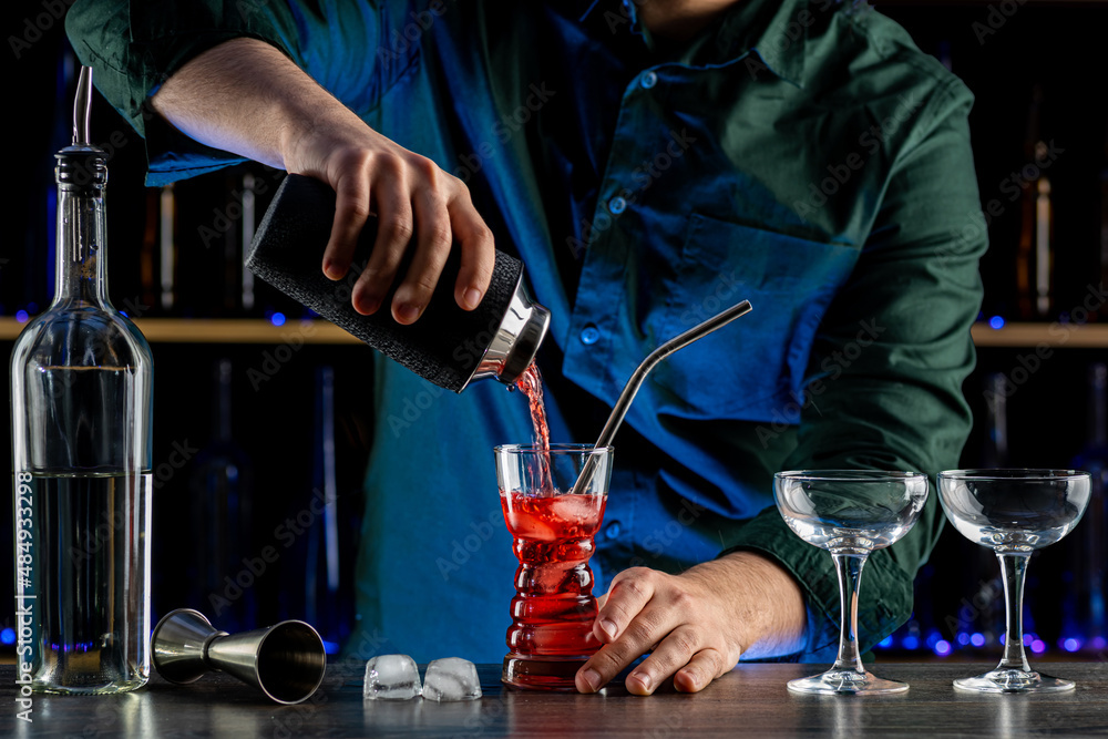Bartender's hands serving cocktails on bar counter in a restaurant, pub ...