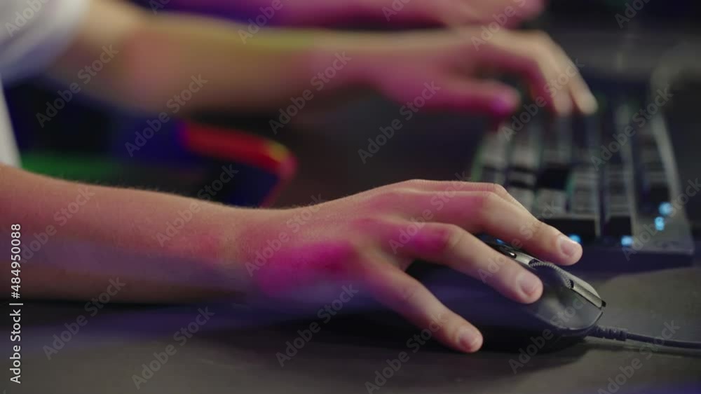 Close-up of a pc gamer controlling the mouse in the computer arena. A ...