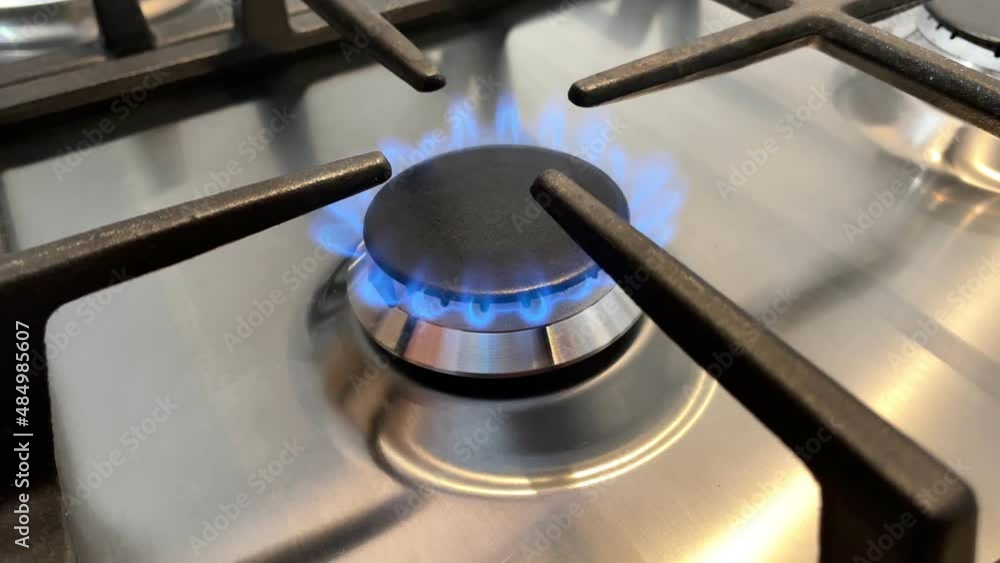Turning on the cooktop gas cooker. Natural gas at home. Gas Flame Stock ...