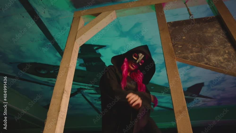 Young sexy woman in mask and black Halloween executioner costume ...