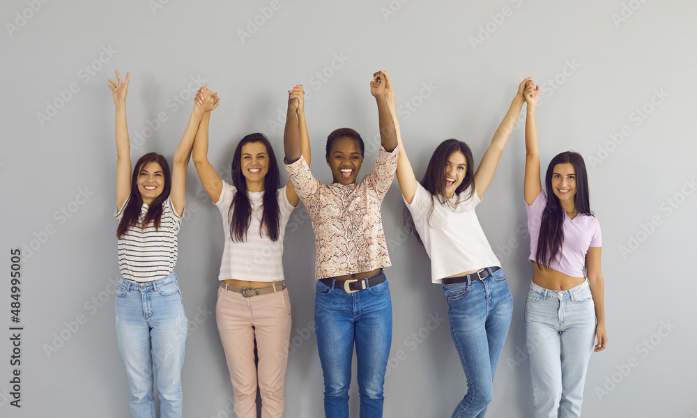 Group portrait of positive confident diverse ladies holding hands. Team ...
