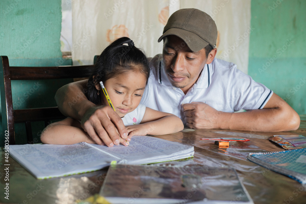 Hispanic dad helping his little daughter do her homework - Teacher ...