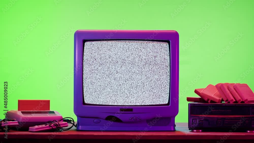 Old television with grey interference screen on purple neon background ...