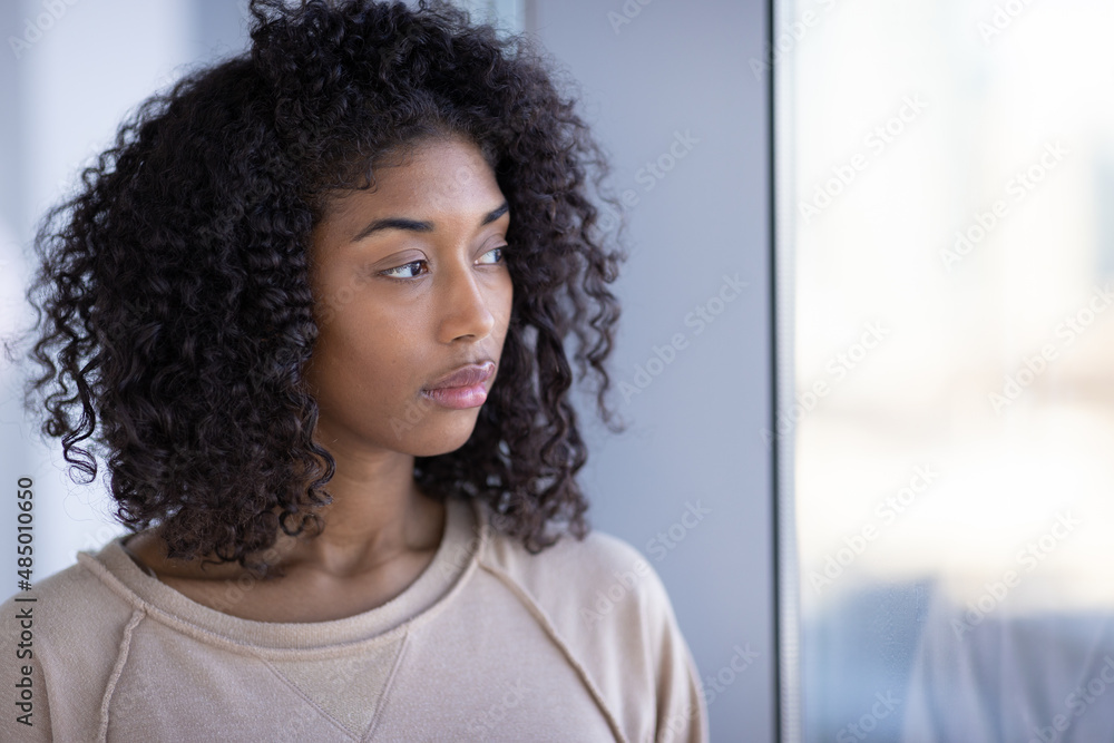 Poster Young black woman at home sad depressed serious face portrait ...