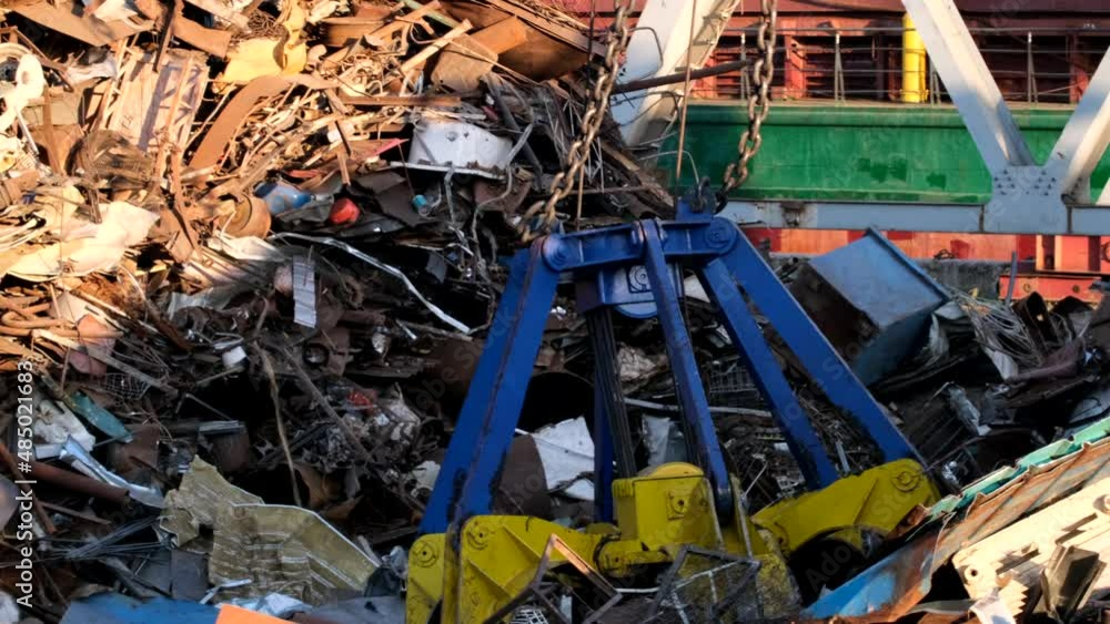 Metal scrap being loaded into a ship for recycling. Recycling metal ...