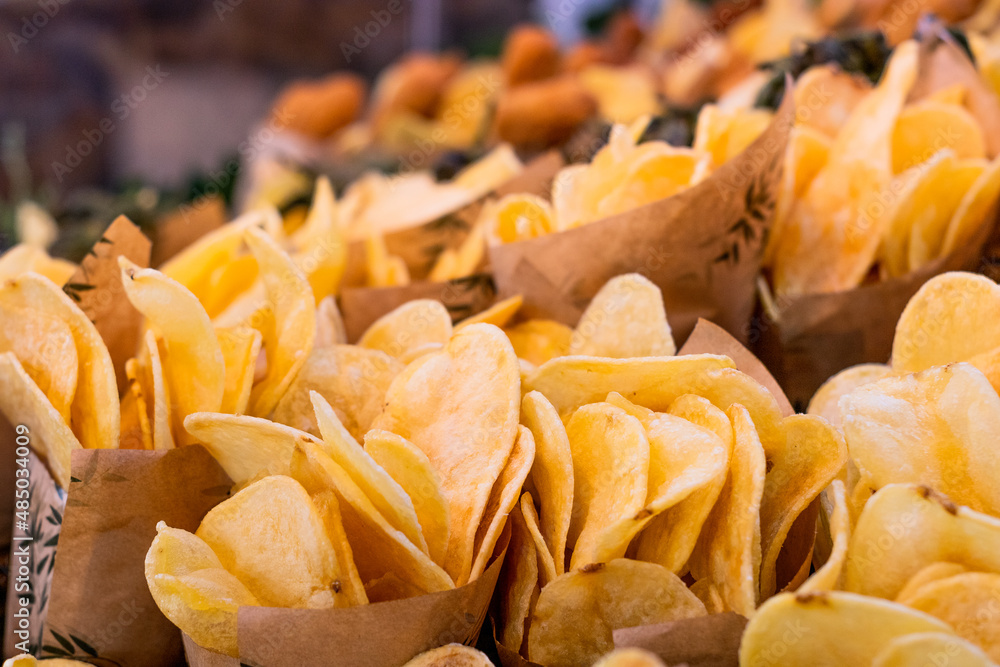 Potato packets chips in the market stall ready to be eaten by tourists ...