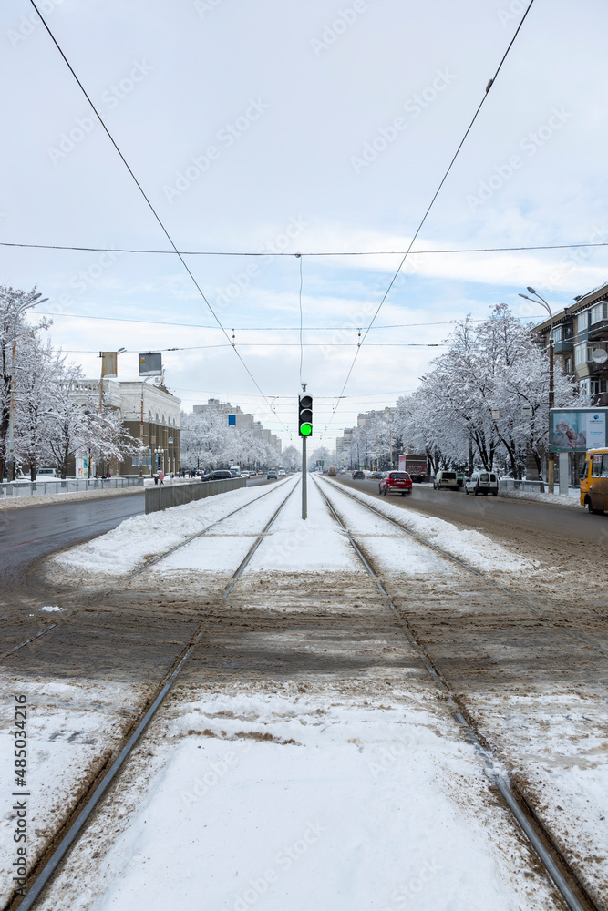 Traffic light with green signal in the center of the street between the ...