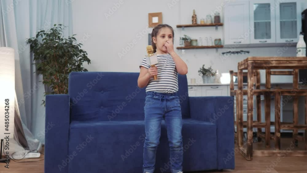 little child daughter a sing dancing at home. stay home active leisure ...