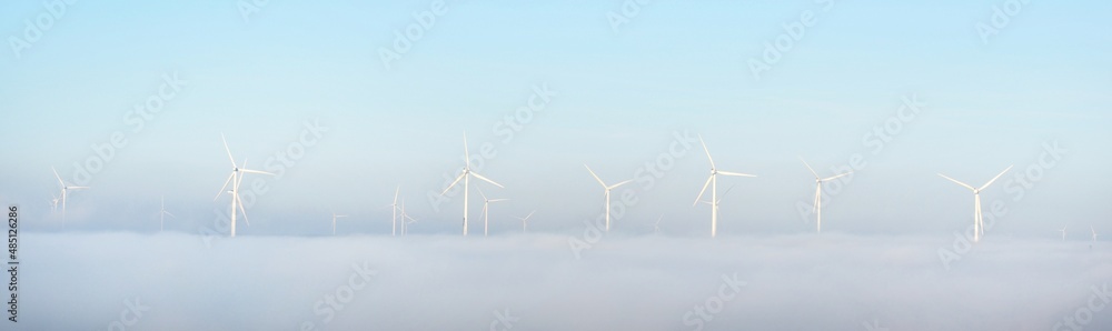 Wind turbine generators in a clouds of fog, close-up. Concept image ...