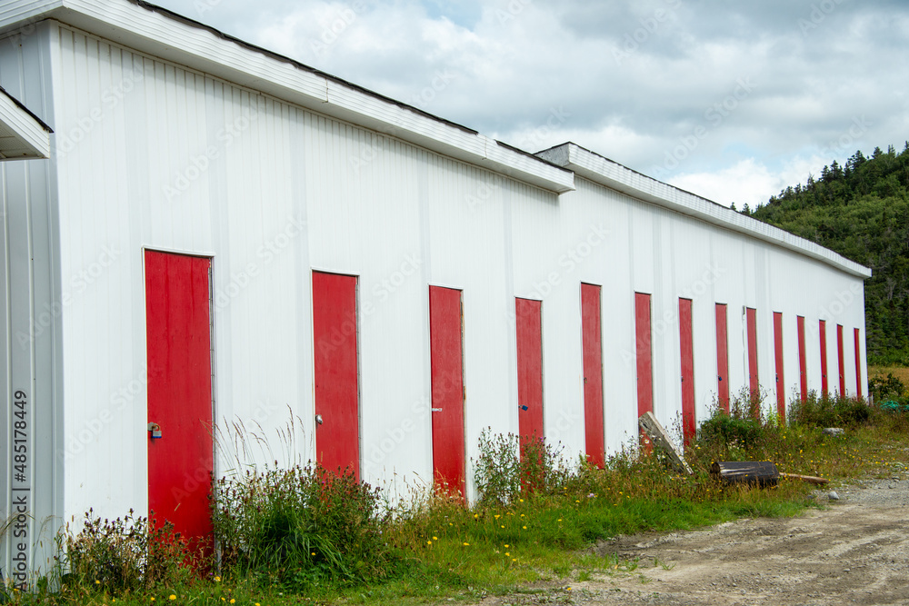 The exterior of a white concrete commercial building with a flat roof ...