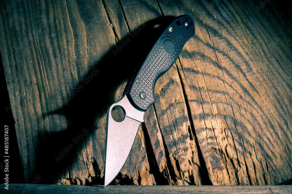 Knife with a hole in the blade. A knife and a hard shadow from it ...