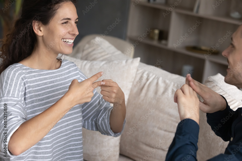 Smiling Hispanic woman who is deaf using sign language, communicating ...