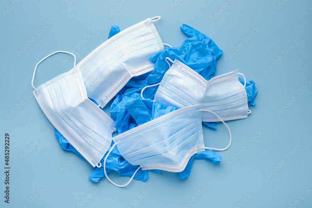 Pile of used disposable medical masks and gloves. The concept of the ...