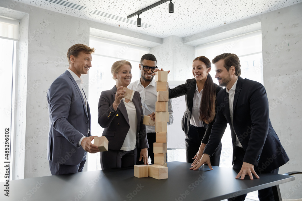 Happy successful diverse business team of different ages building ...