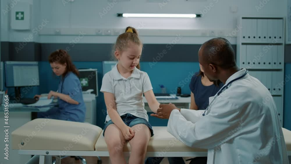 Hurt child with injured arm attending consultation with physician in ...