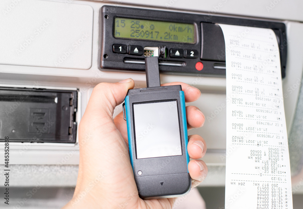 Foto de Driver holding a digital tachograph reader with isolated white ...