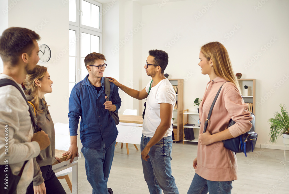 Young freshman students have fun casual conversation together in ...