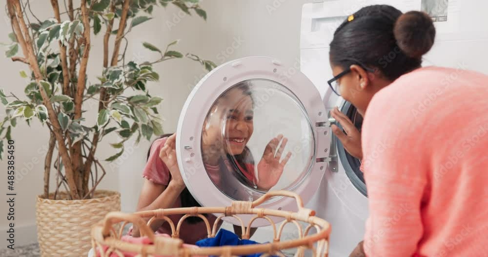 Fooling around, joking, playing while doing household chores, woman and ...