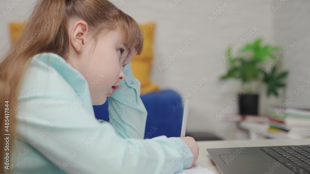 Kid, girl studies at home at computer. Online school, kid, daughter ...