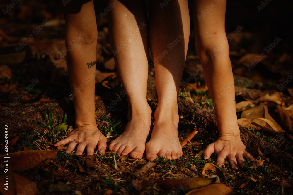 Woman hands and feet touching the ground. Earth power connection Stock ...