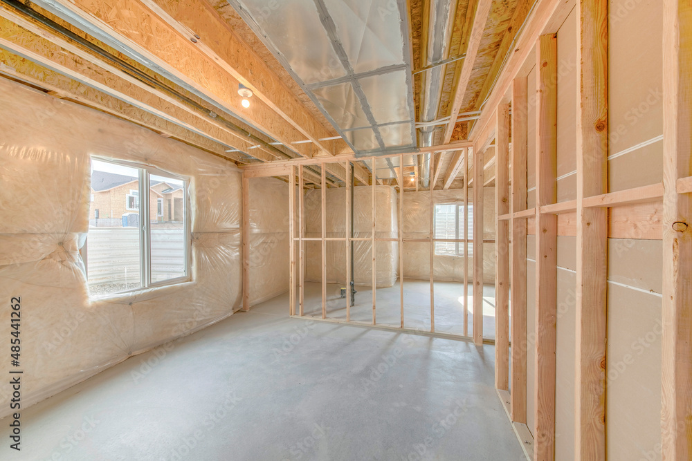 Unfinished basement with wood framing and insulated walls Stock Photo ...