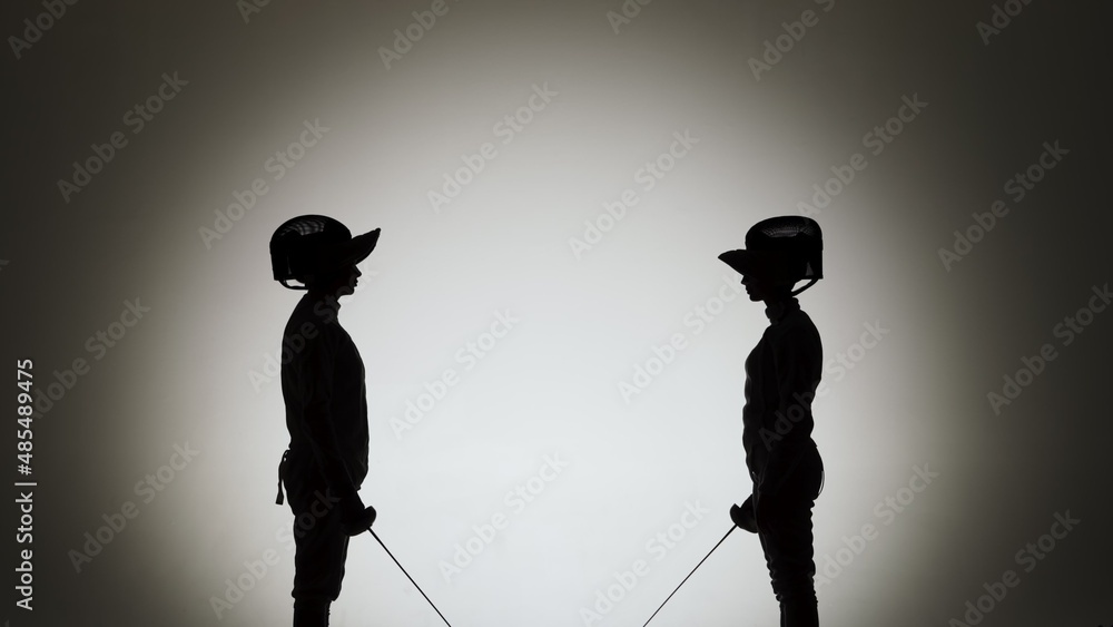 Black silhouettes of two female swordsmen fighting a duel. Athletes ...
